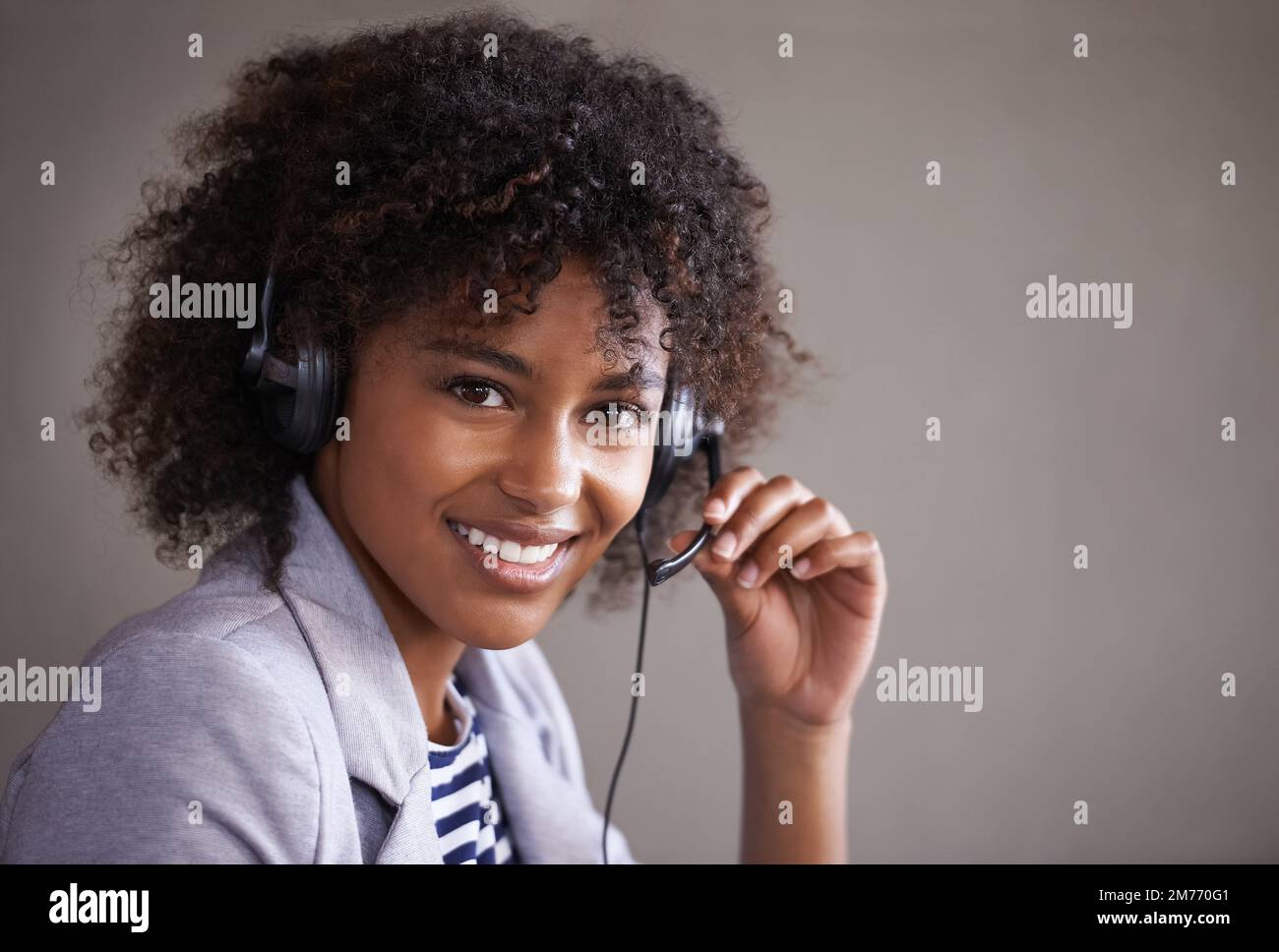Helping clients puts a smile on her face. Portrait of a happy young ...