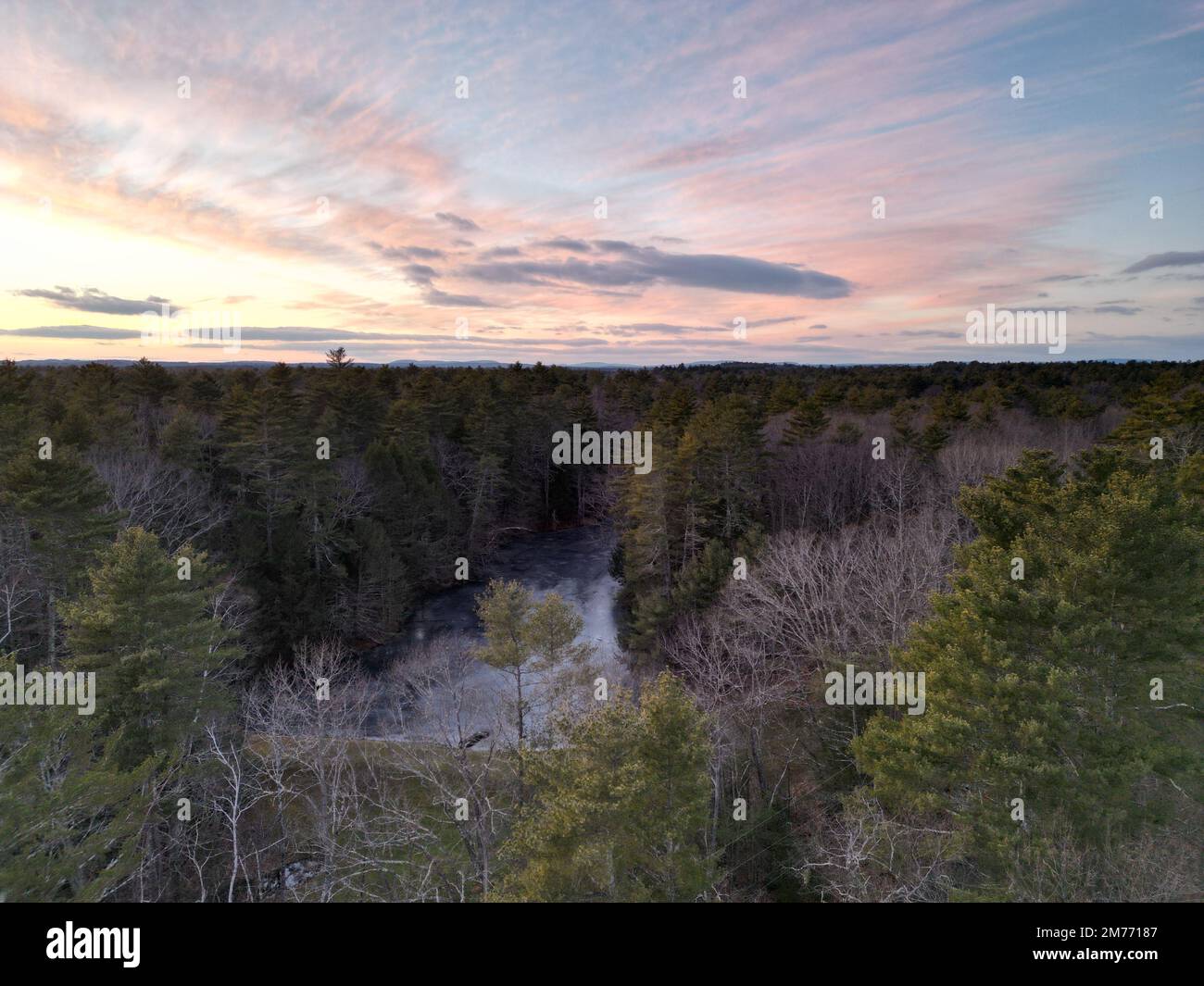 A beautiful view of a sunset over the forest Stock Photo - Alamy