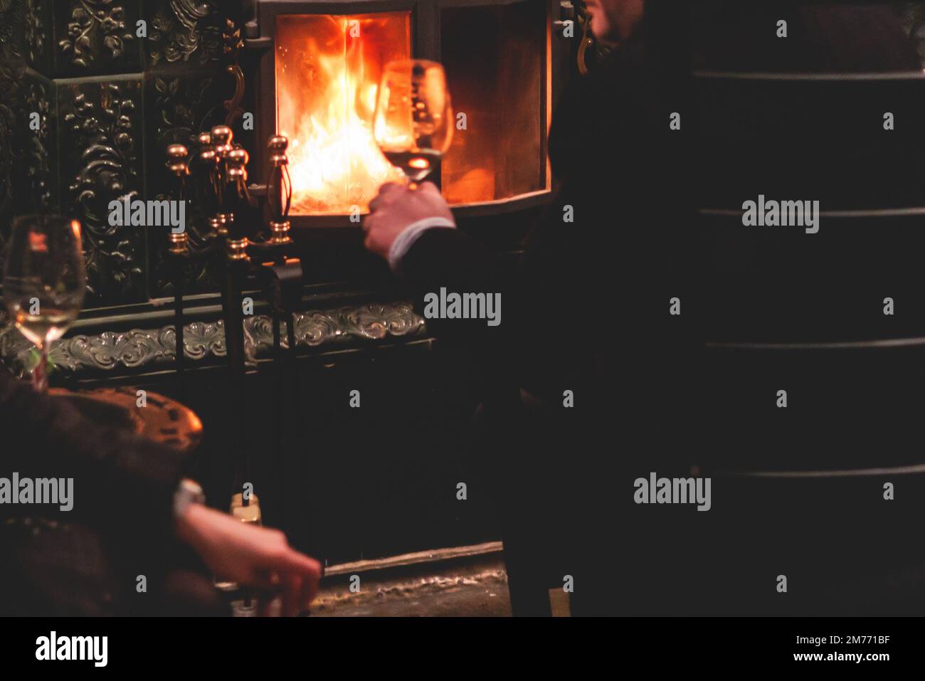 Warming up by the fire, cozy winter night in the cabin house by the ...
