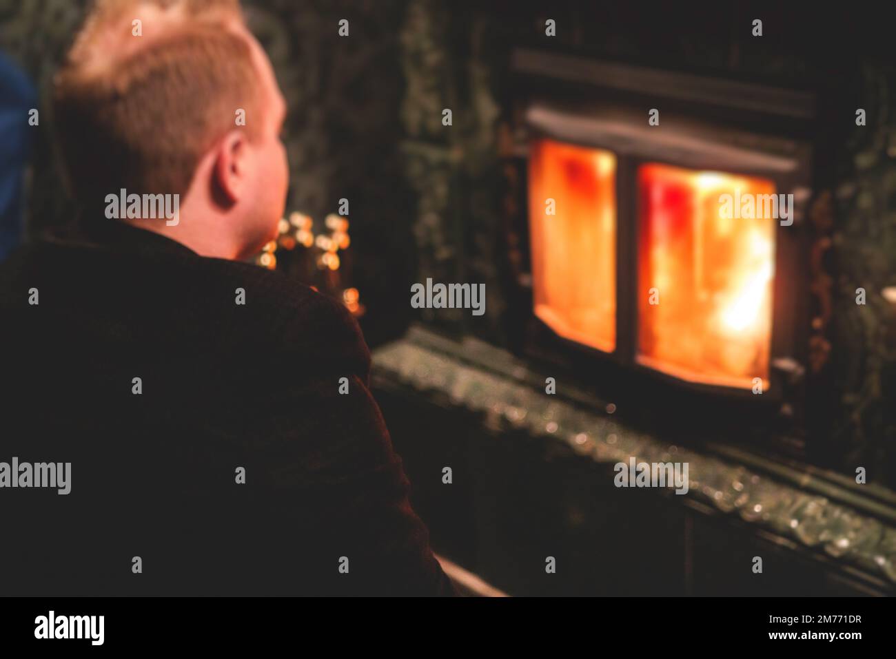 Warming up by the fire, cozy winter night in the cabin house by the ...