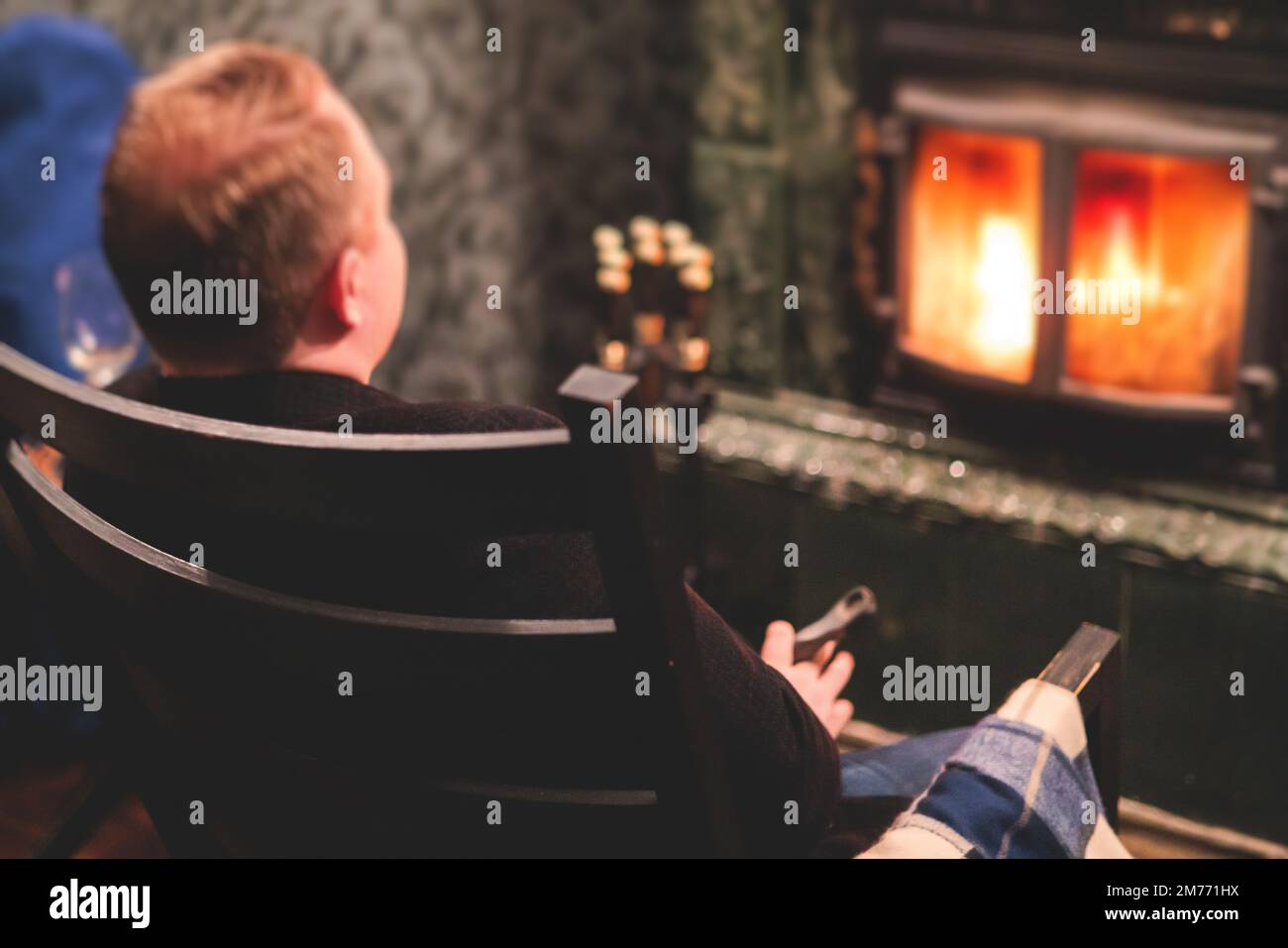 Warming up by the fire, cozy winter night in the cabin house by the ...