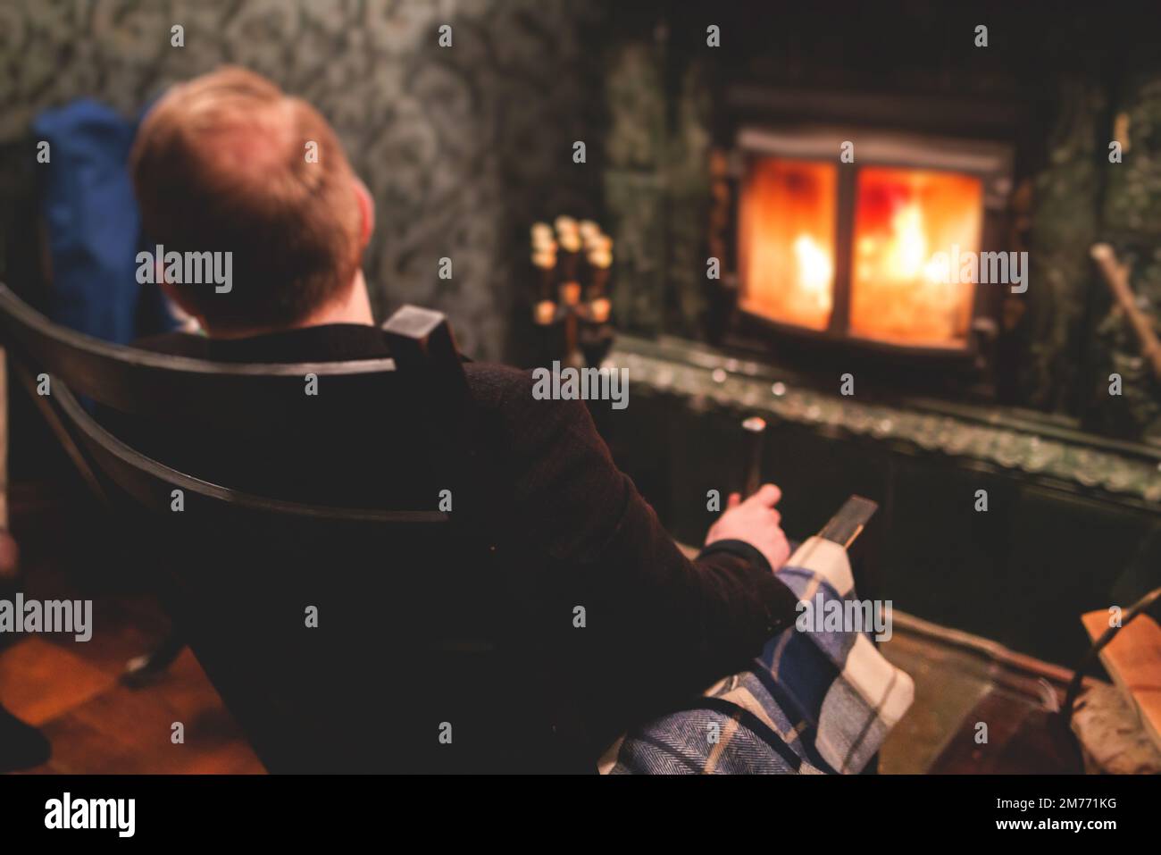 Warming up by the fire, cozy winter night in the cabin house by the ...