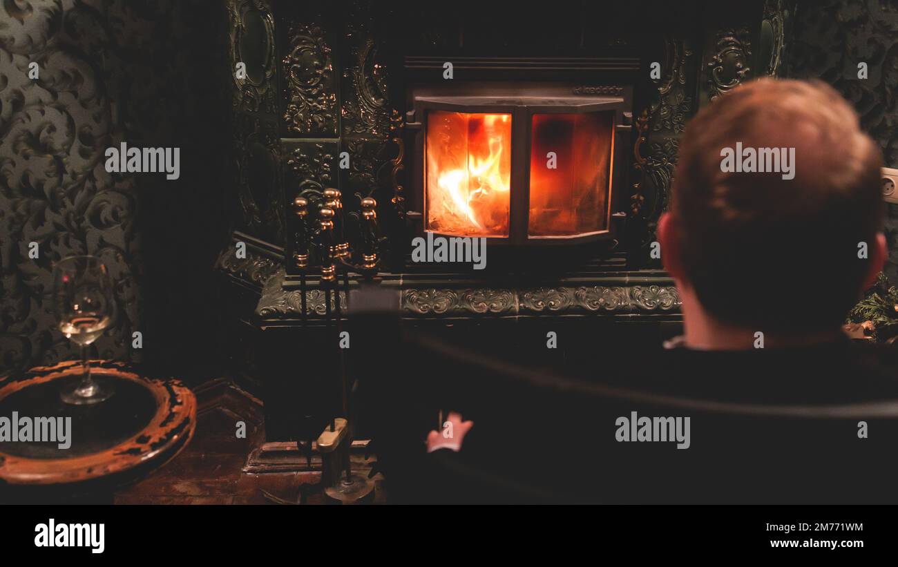 Warming up by the fire, cozy winter night in the cabin house by the ...