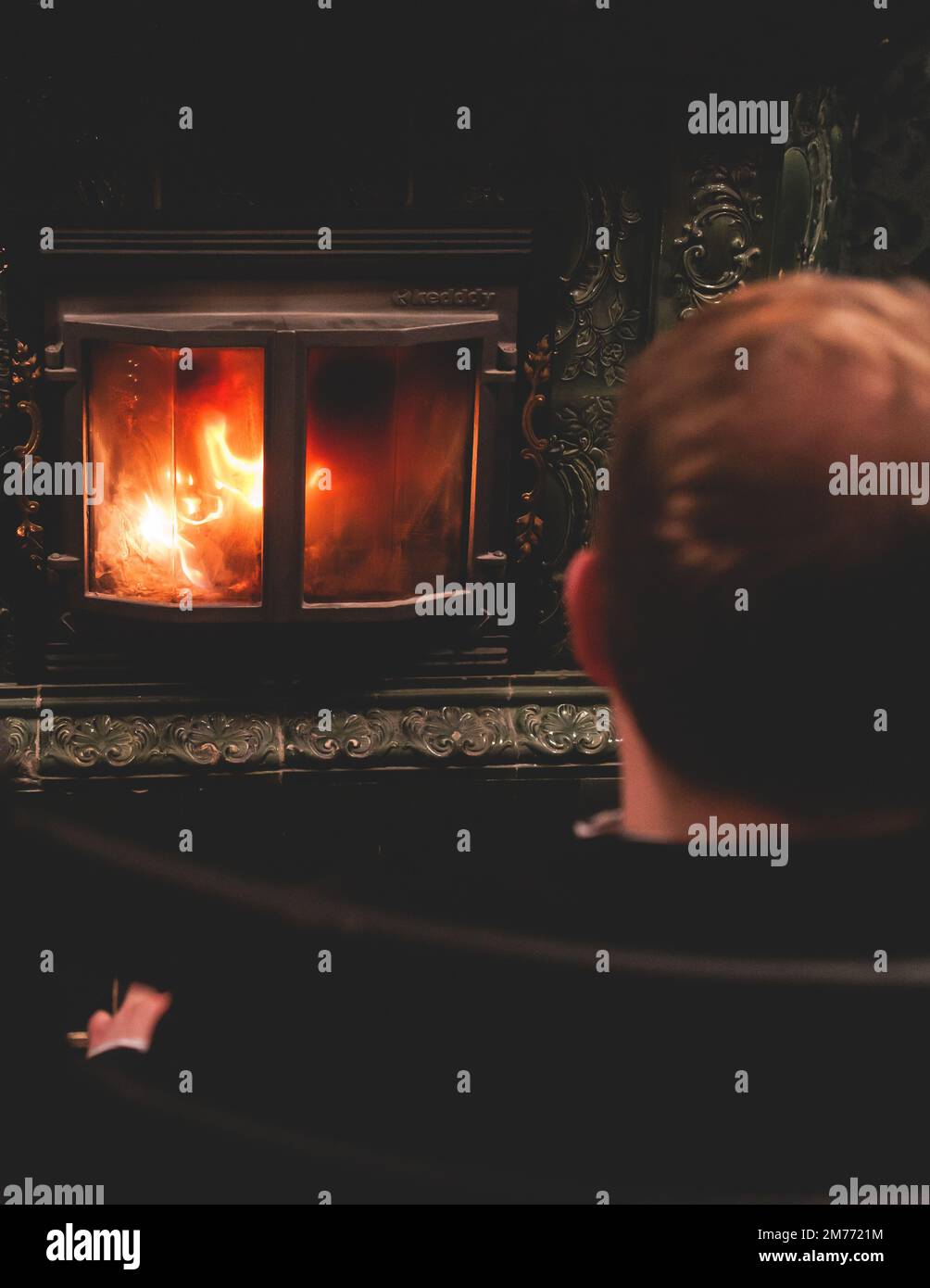 Warming up by the fire, cozy winter night in the cabin house by the ...
