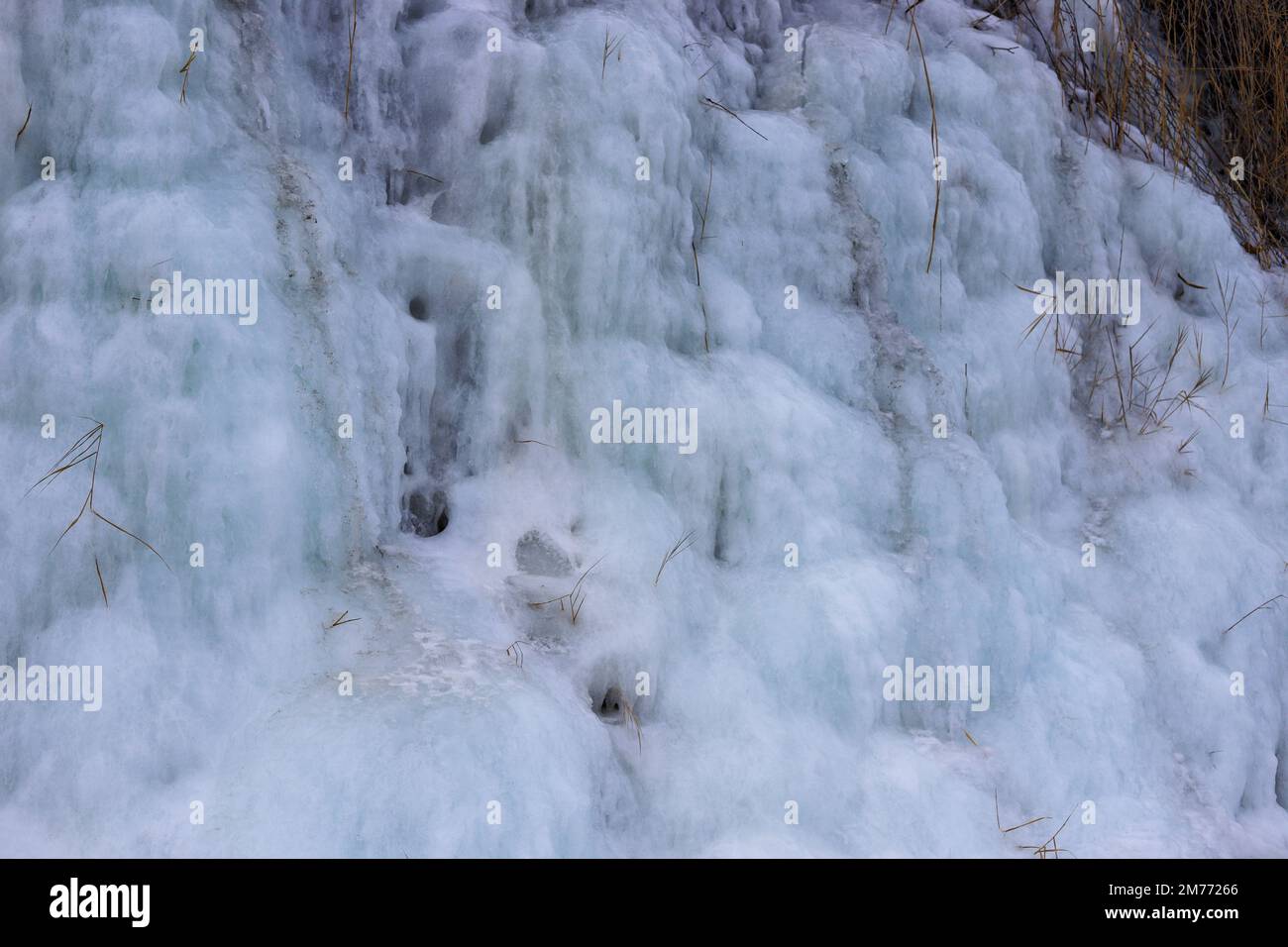 Beautiful ice structures of a frozen waterfall, pretty icicles forming ...