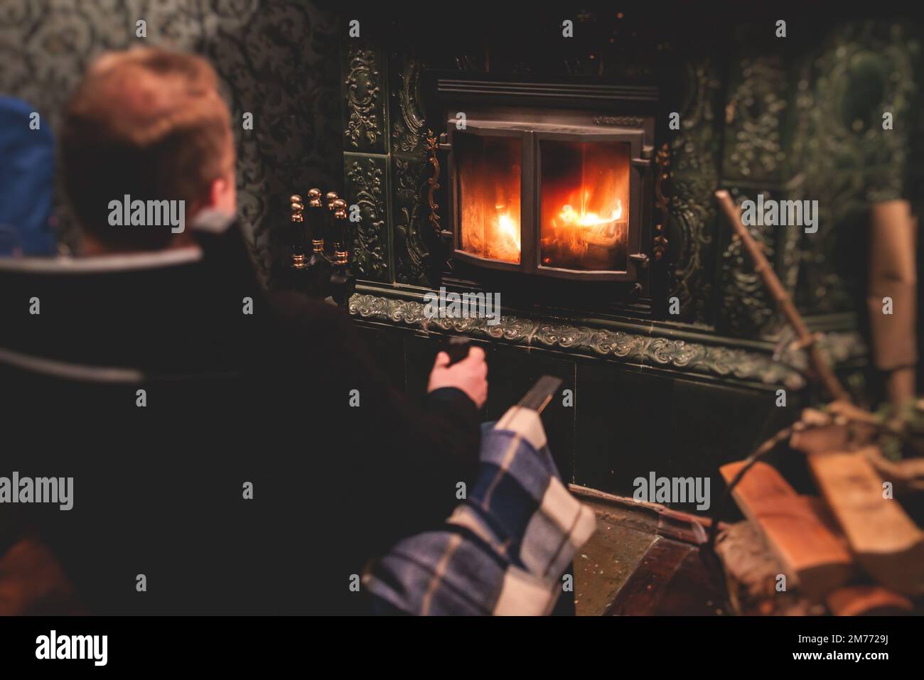 Warming up by the fire, cozy winter night in the cabin house by the ...