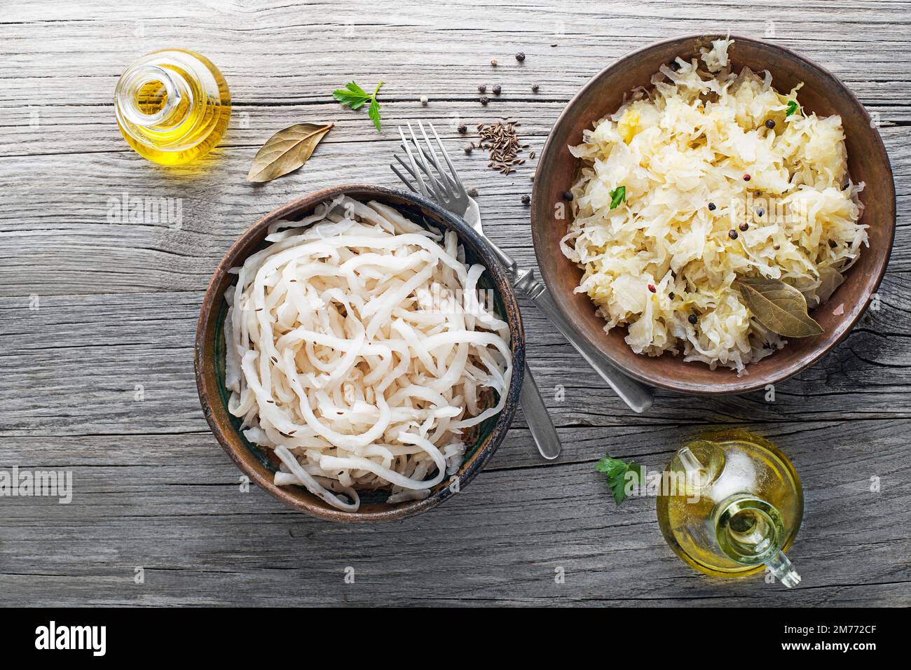 Traditional healthy sauerkraut and sour turnip on wooden background ...