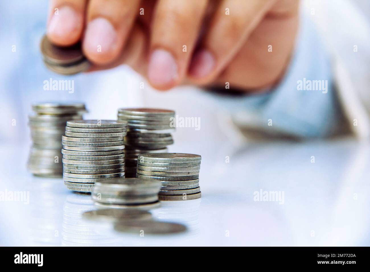 Hand put coin to stack, investment concept Stock Photo - Alamy
