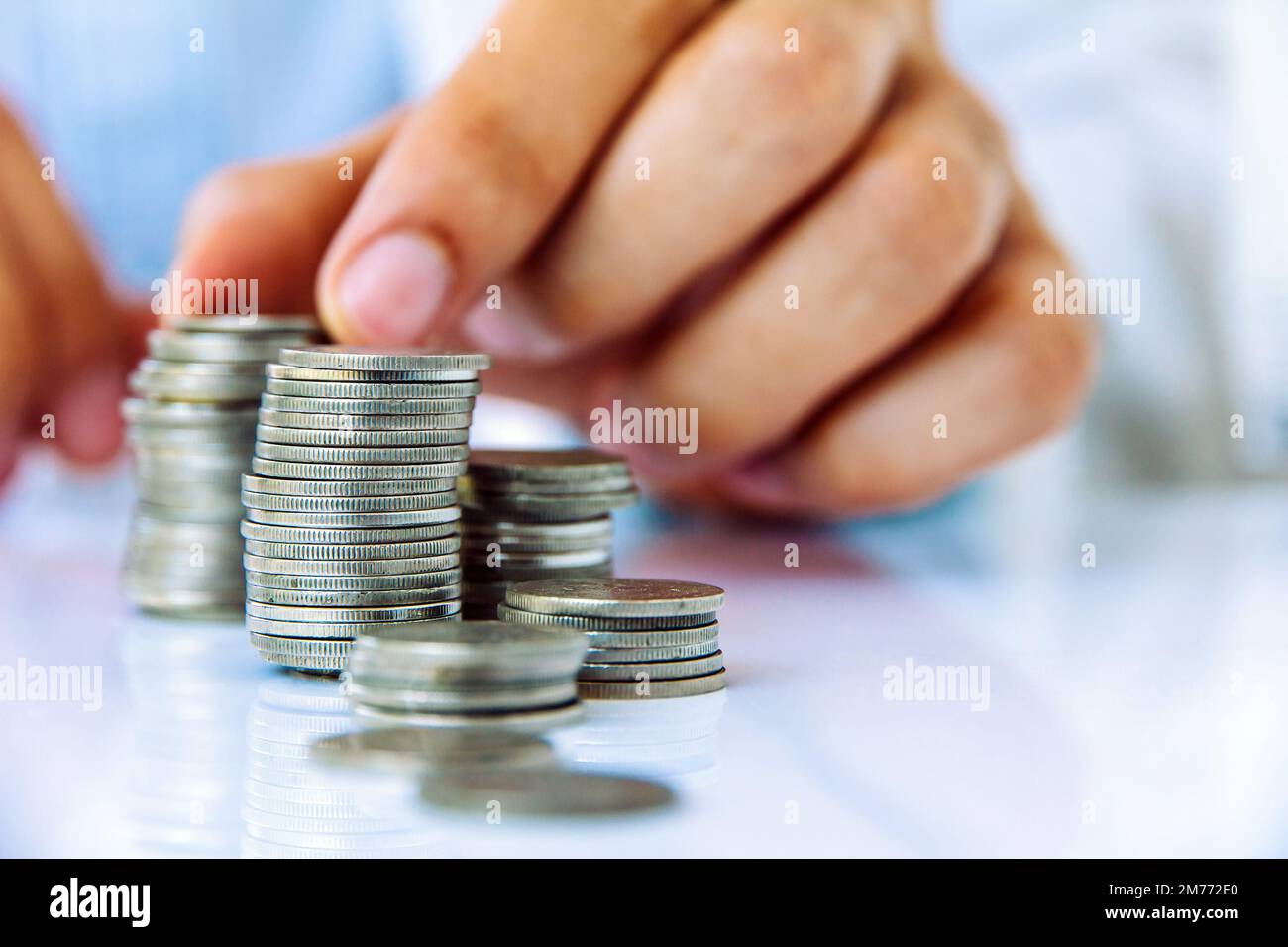 Hand put coin to stack, investment concept Stock Photo - Alamy