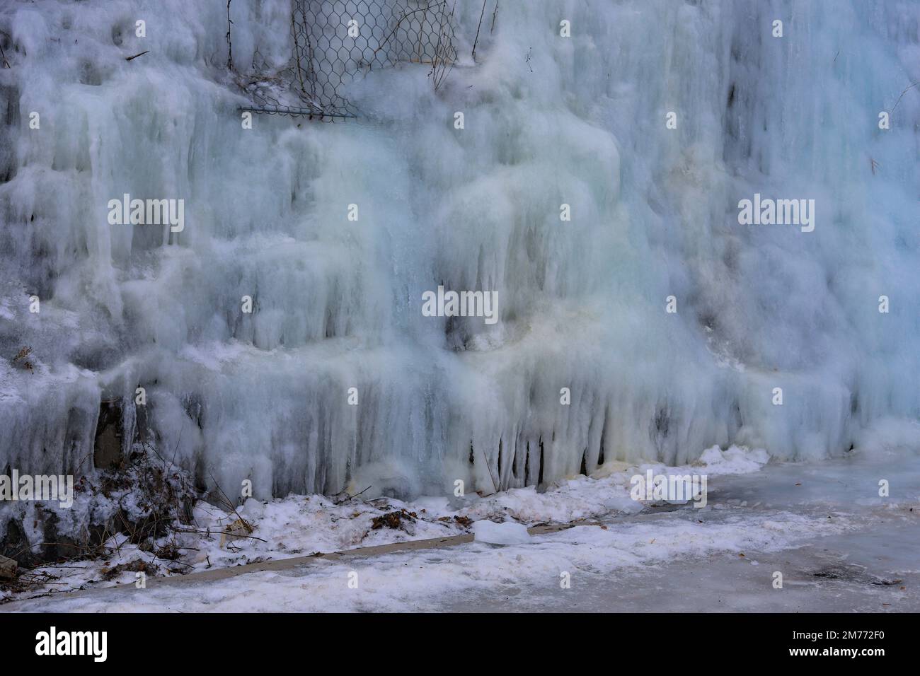 Beautiful ice structures of a frozen waterfall, pretty icicles forming ...