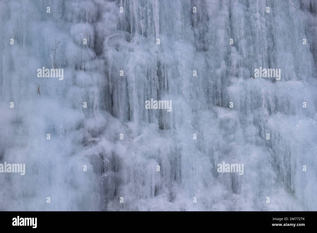 Beautiful ice structures of a frozen waterfall, pretty icicles forming ...