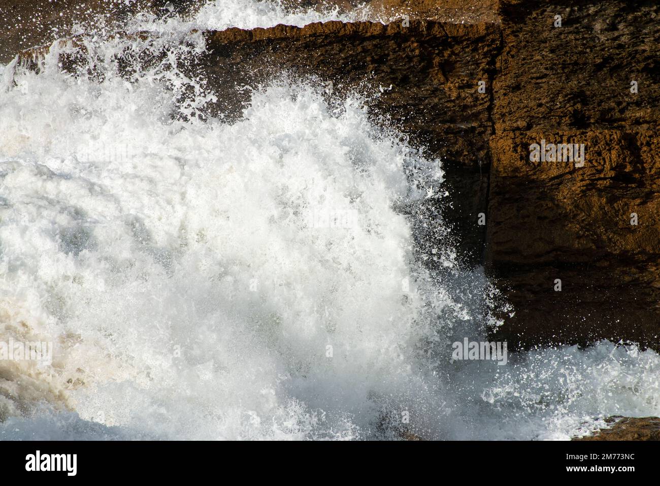 Atlantic Ocean waves crash into dramatic layered rock formations near ...