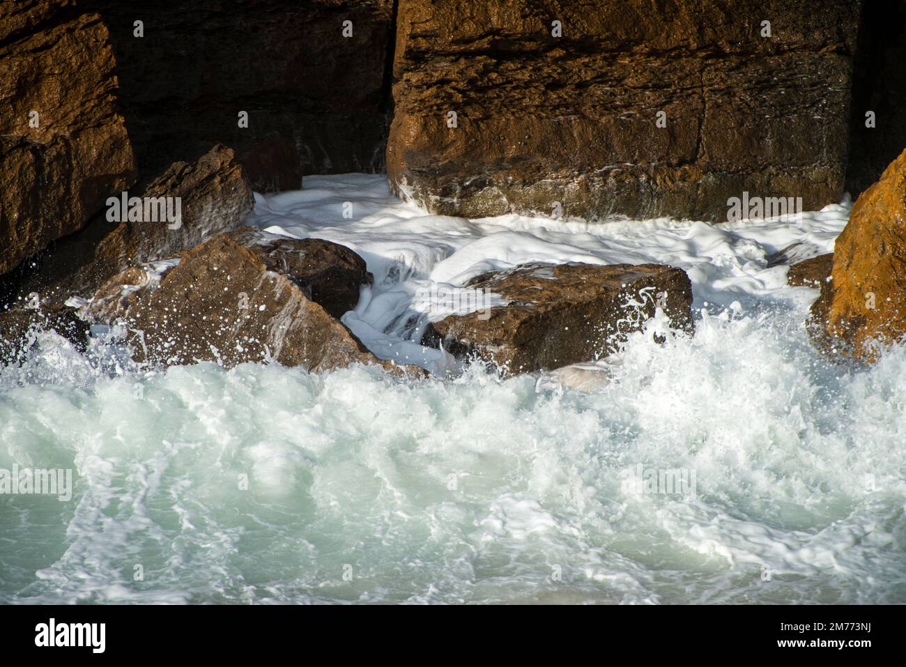 Atlantic Ocean waves crash into dramatic layered rock formations near ...