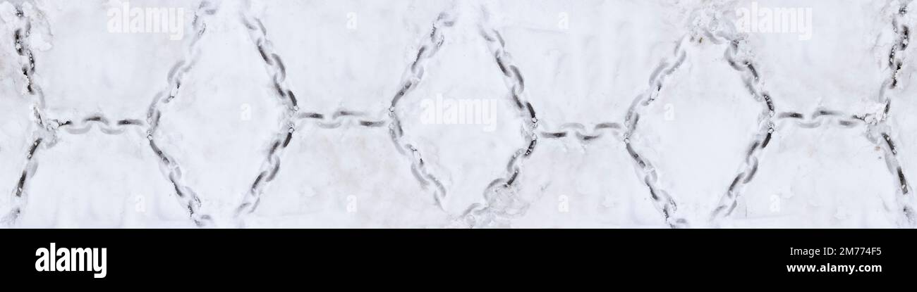 Tire texture on snow. Snow chain marks on an icy road. Track from the ...