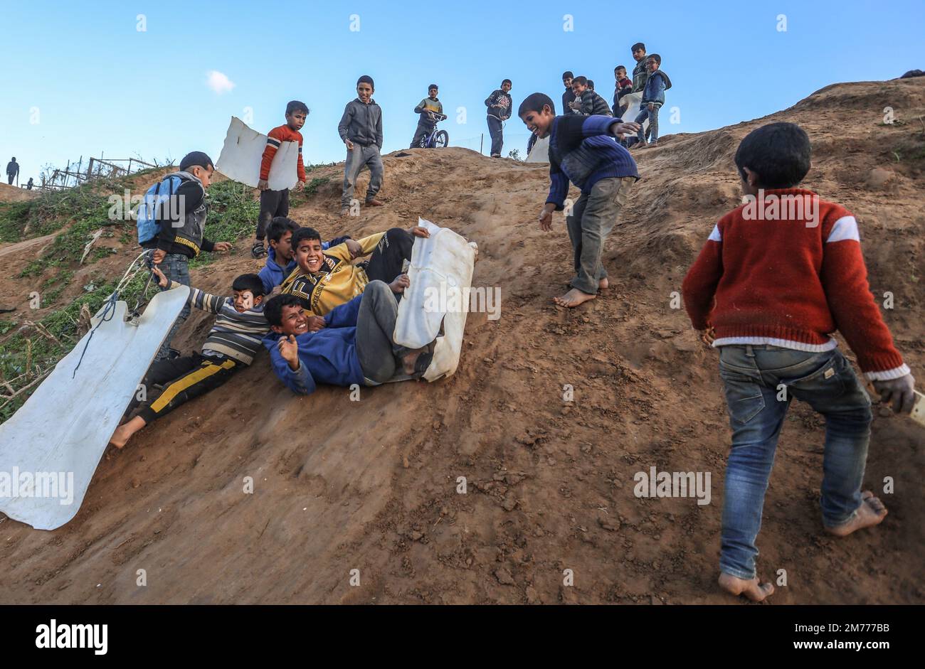 Palestinian children seen playing in front of their house in the ...