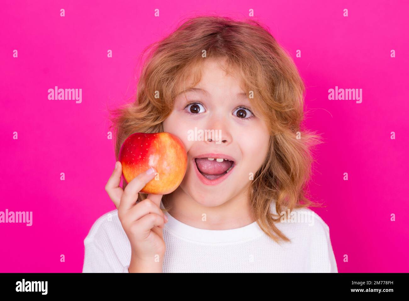 Kids face with fruits. Kid with apple in studio. Studio portrait of ...