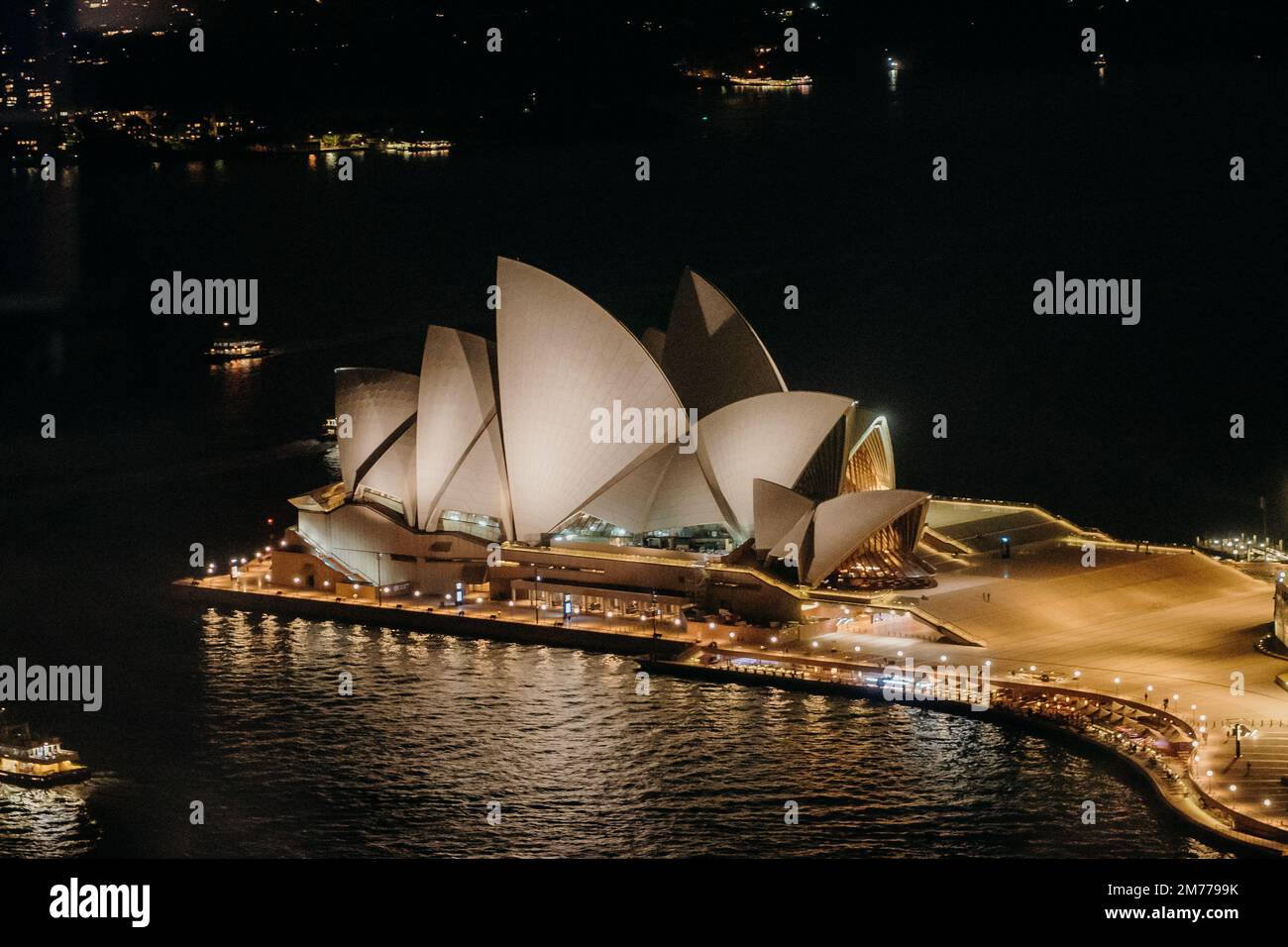 An aerial view of the beautiful Sydney Opera House illuminated at night ...