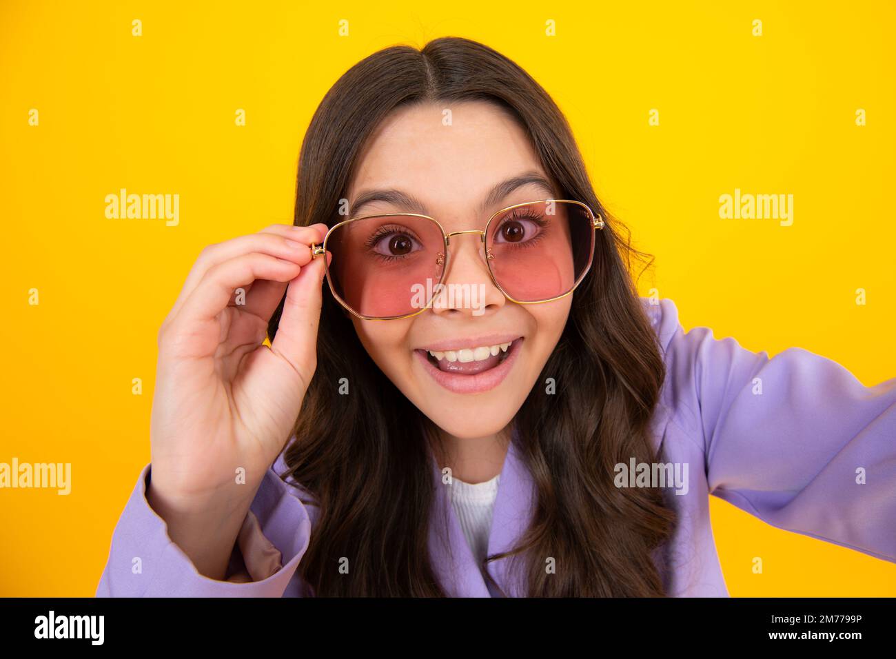 Headshot portrait of cute teenager child girl isolated on yellow studio ...