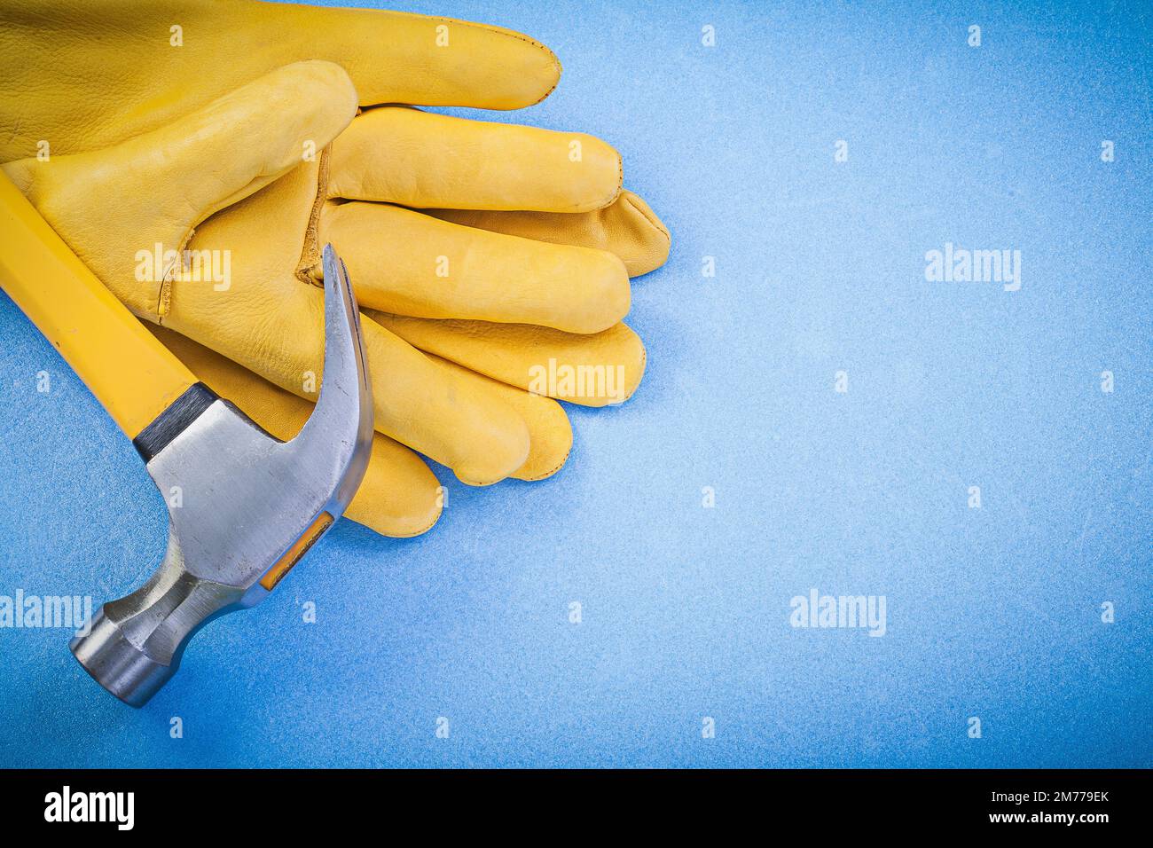 Claw hammer leather safety gloves on blue background construction ...
