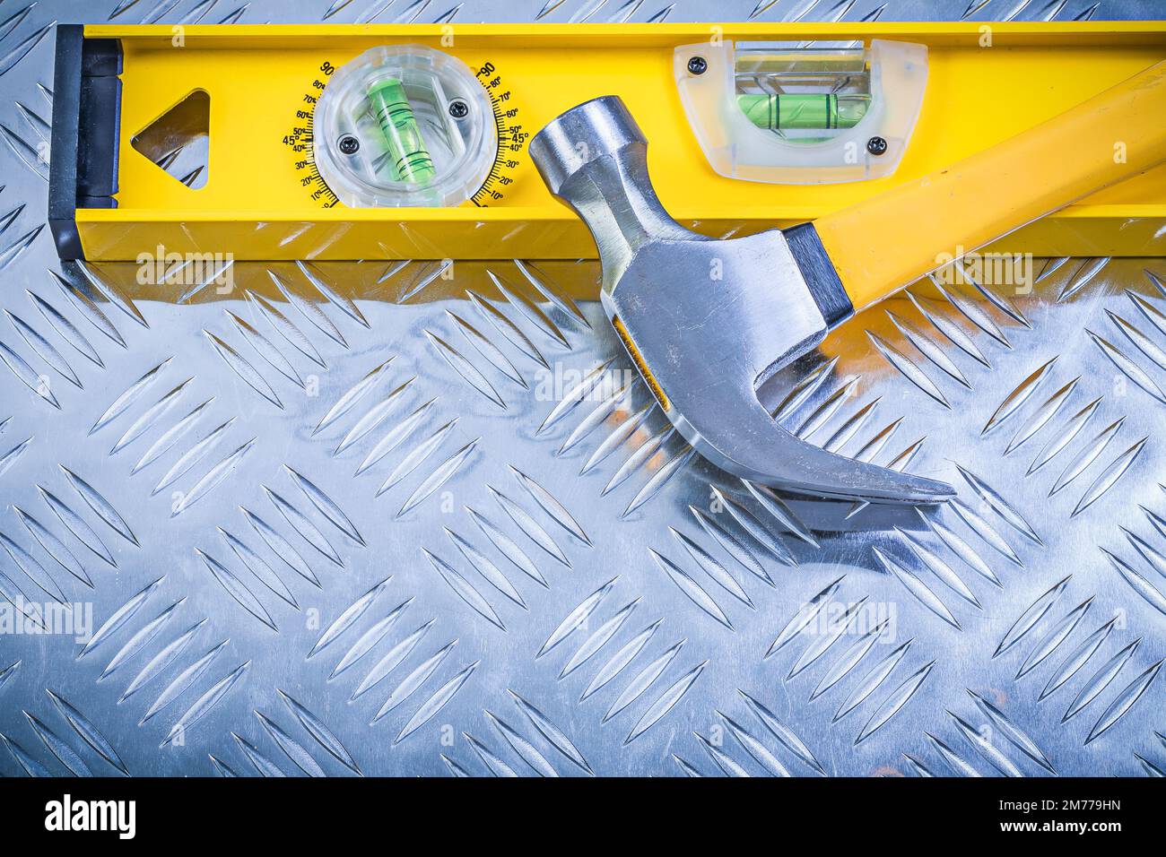 Claw hammer construction level on fluted metal background Stock Photo ...