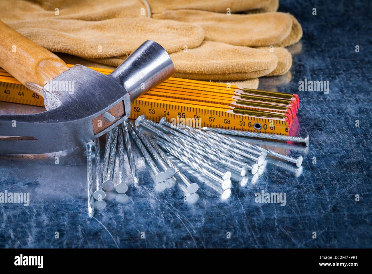 Close up view of safety construction gloves nails wooden measuring ...