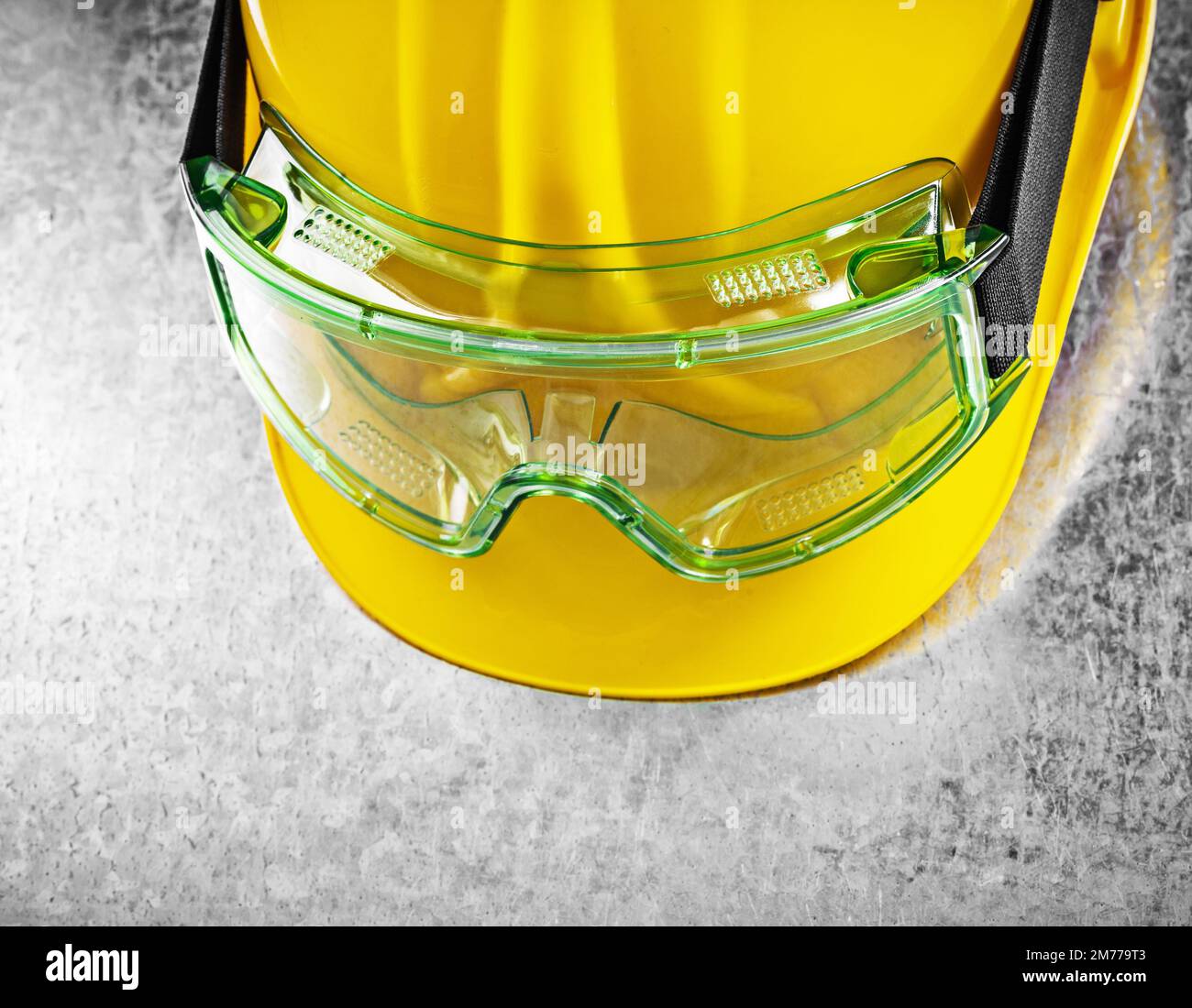 Close up view of safety hard hat and transparent plastic glasses on ...