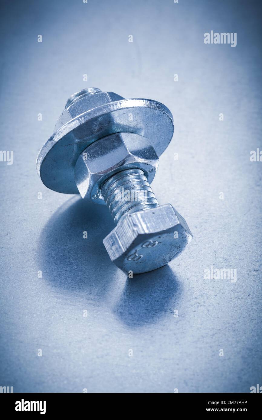 Metal screwbolt with bolt washer and screw nuts on metallic background ...