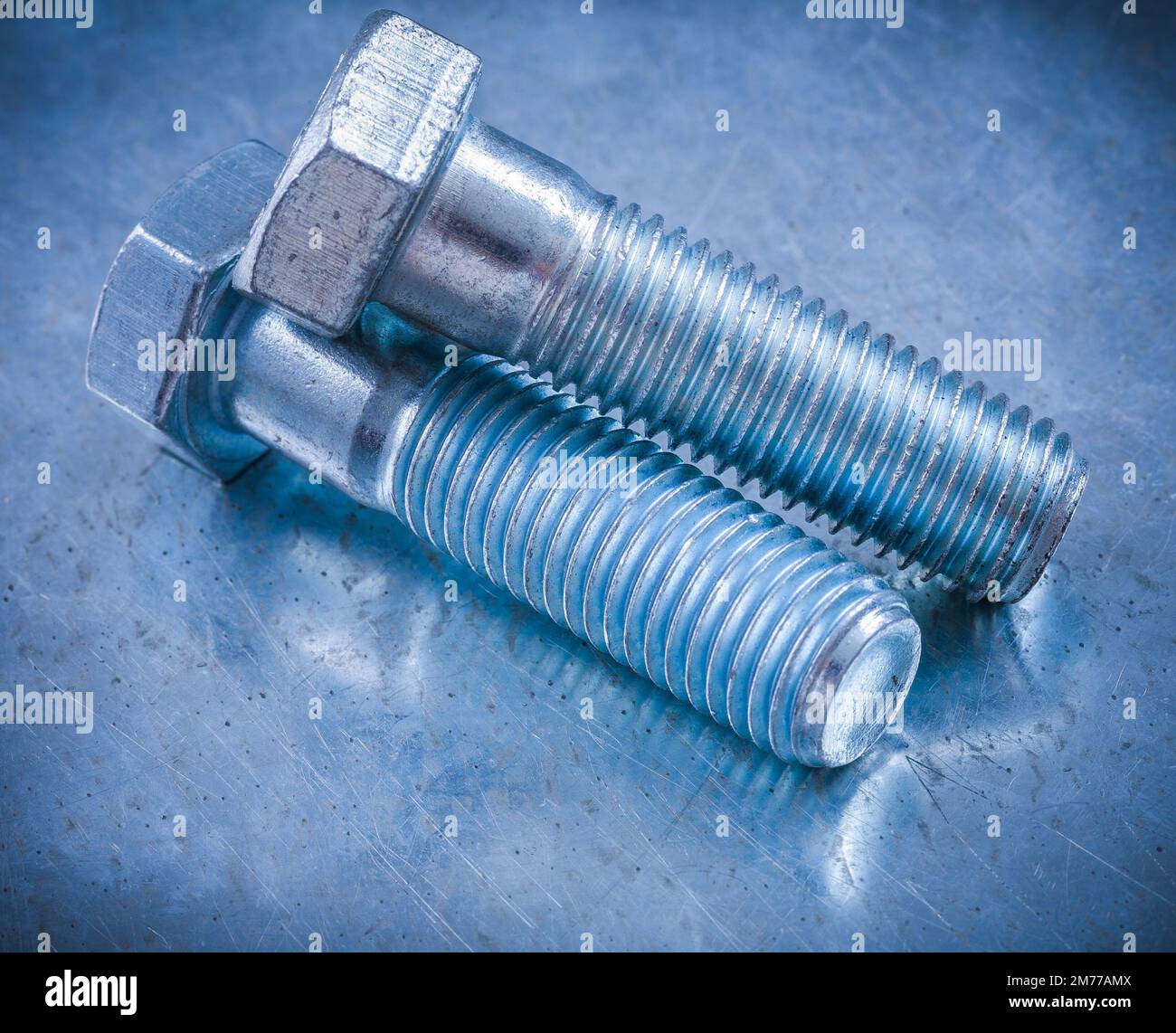 Metal threaded bolts on metallic background construction concept Stock ...