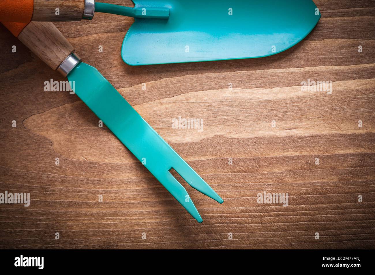 Metal weeding scoop hand spade on wood board agriculture concept Stock ...