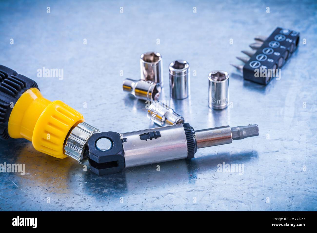 Metallic background with stainless reversible screwdriver steel screw ...