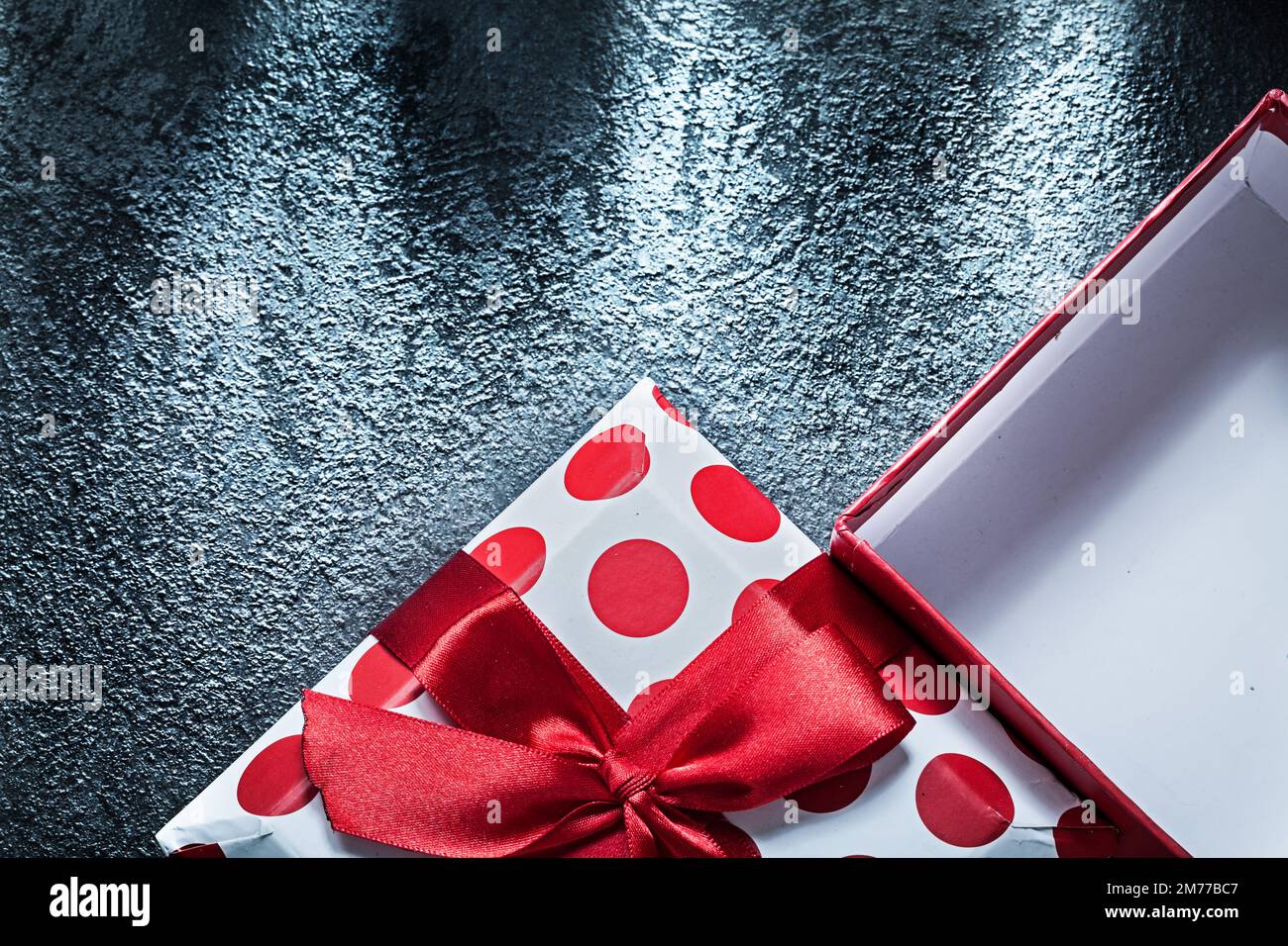Opened boxed present with tied bow on black background celebrations ...
