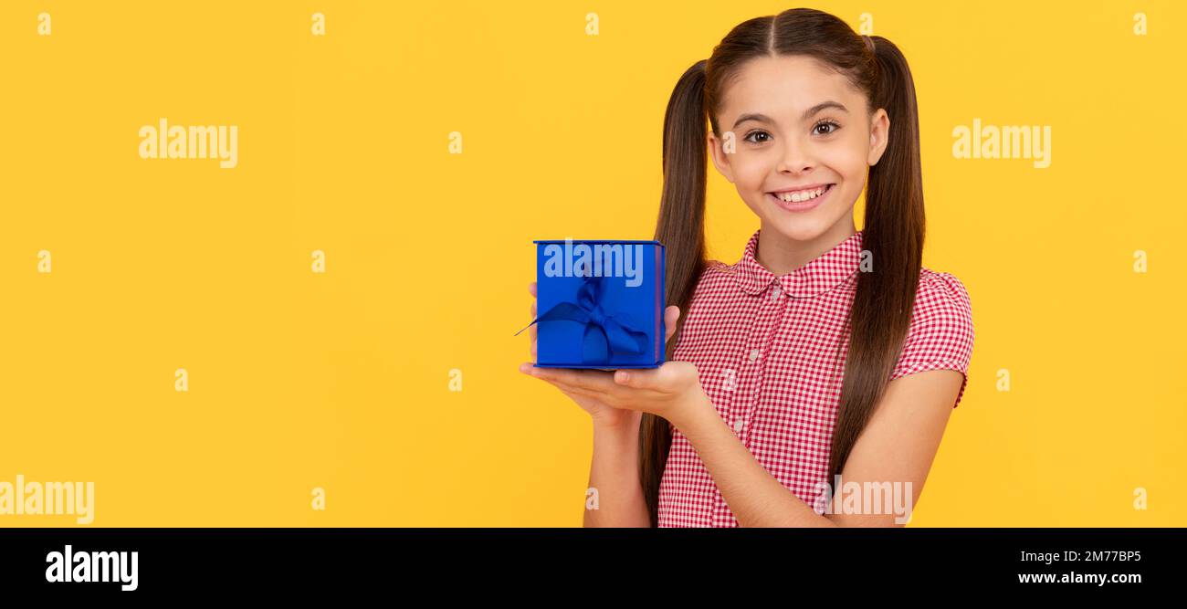 happy child hold present box on yellow background. Kid girl with gift ...