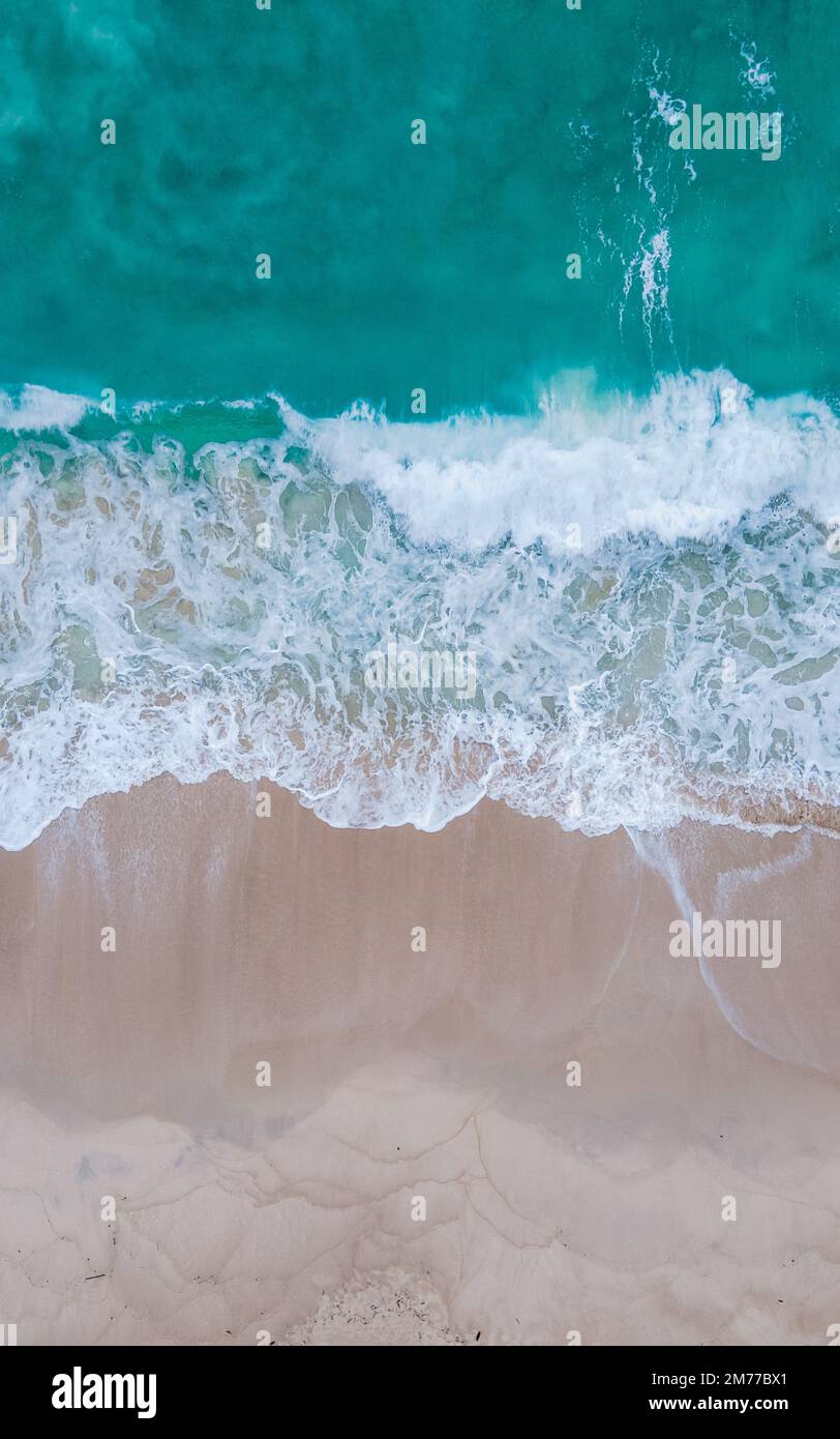 Top view at a tropical beach with waves and blue ocean Drone aerial ...