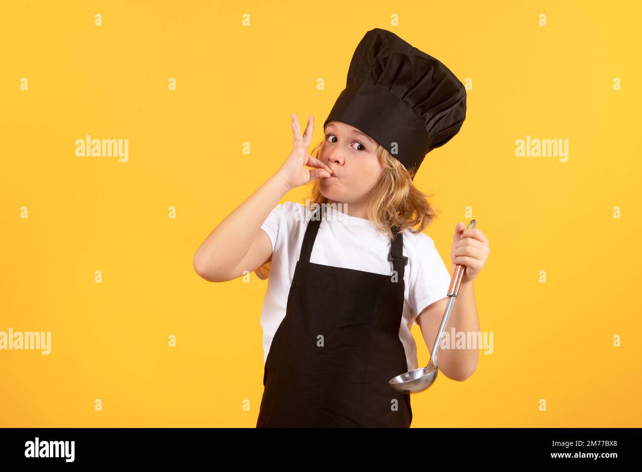 Funny kid chef cook with kitchen ladle, studio portrait. Kid in cooker ...