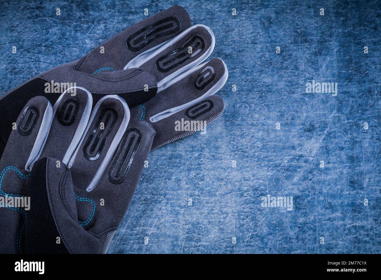 Pair of fabric working gloves on scratched metallic surface Stock Photo ...
