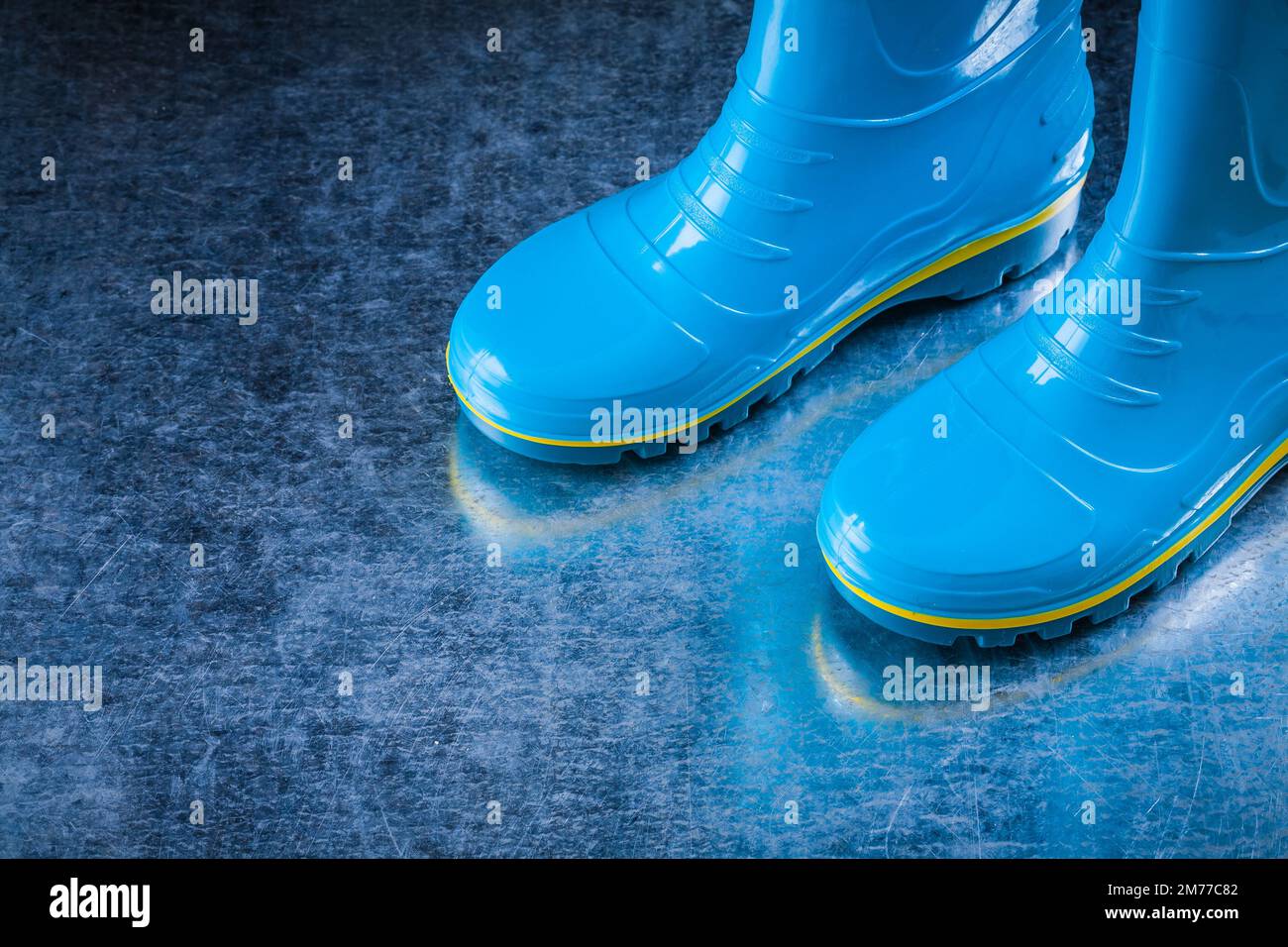 Pair of waterproof gum boots on scratched metallic surface Stock Photo ...
