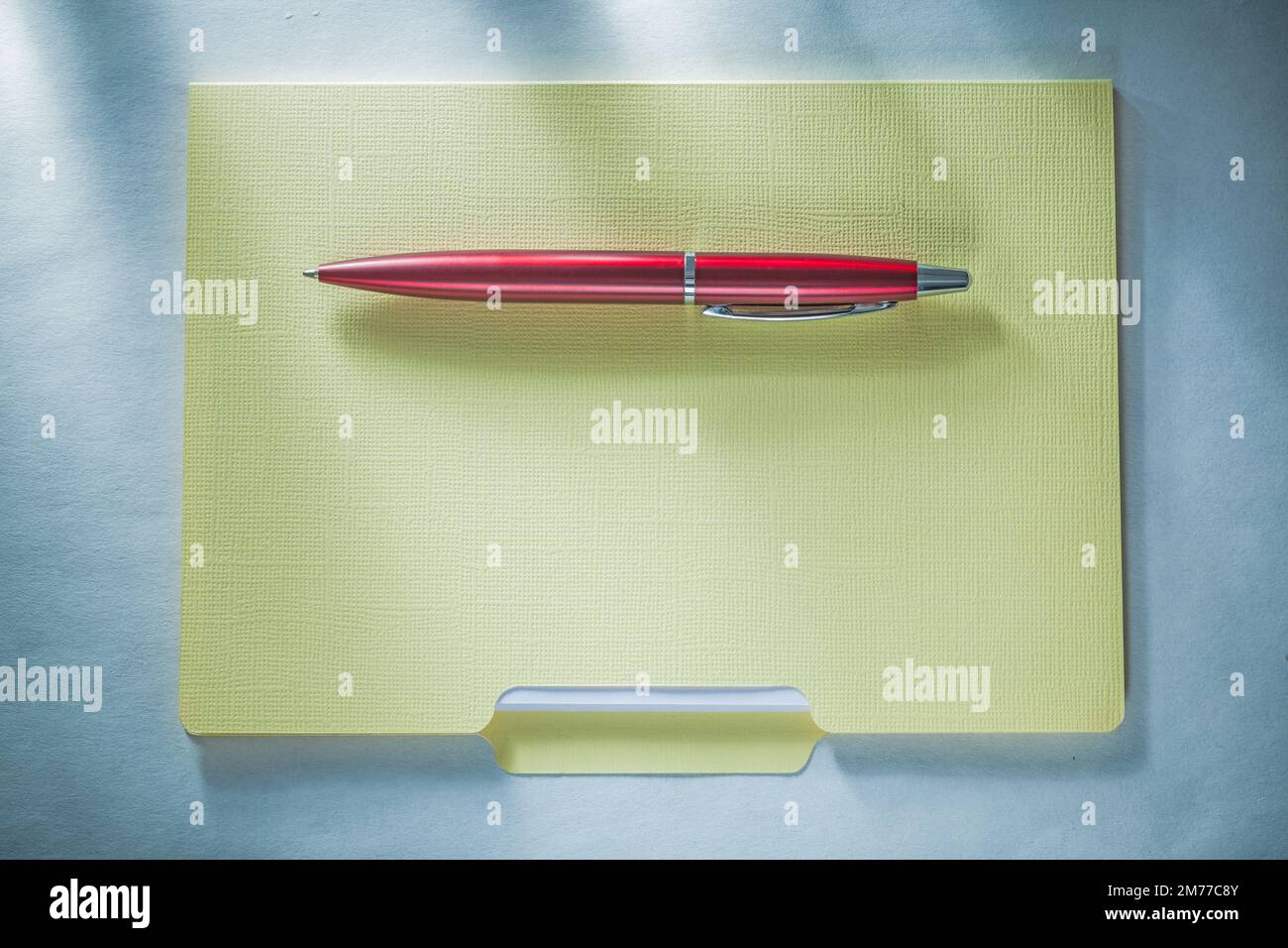 Paper folder biro pen on white background Stock Photo - Alamy