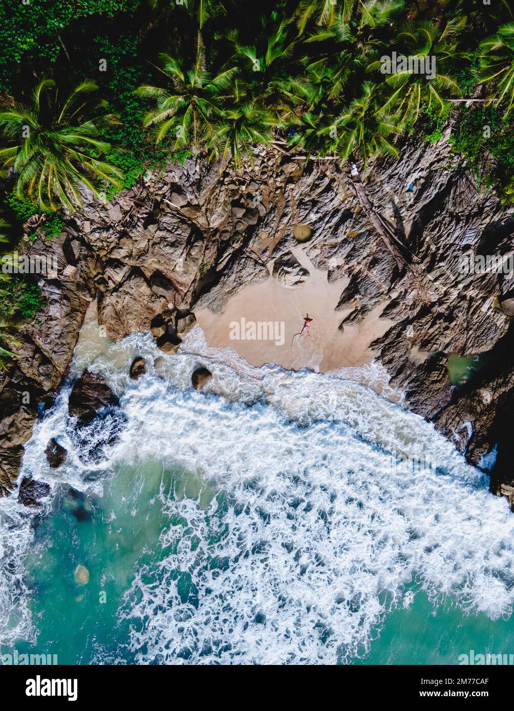 Drone aerial view at Freedom beach in Phuket Thailand, men laying down ...