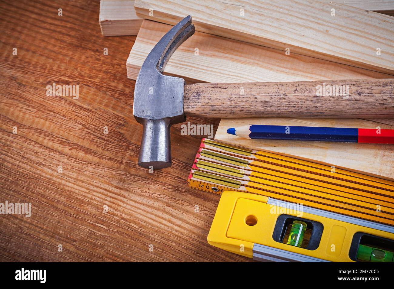 Pencil wooden meter and bricks construction level claw hammer on ...