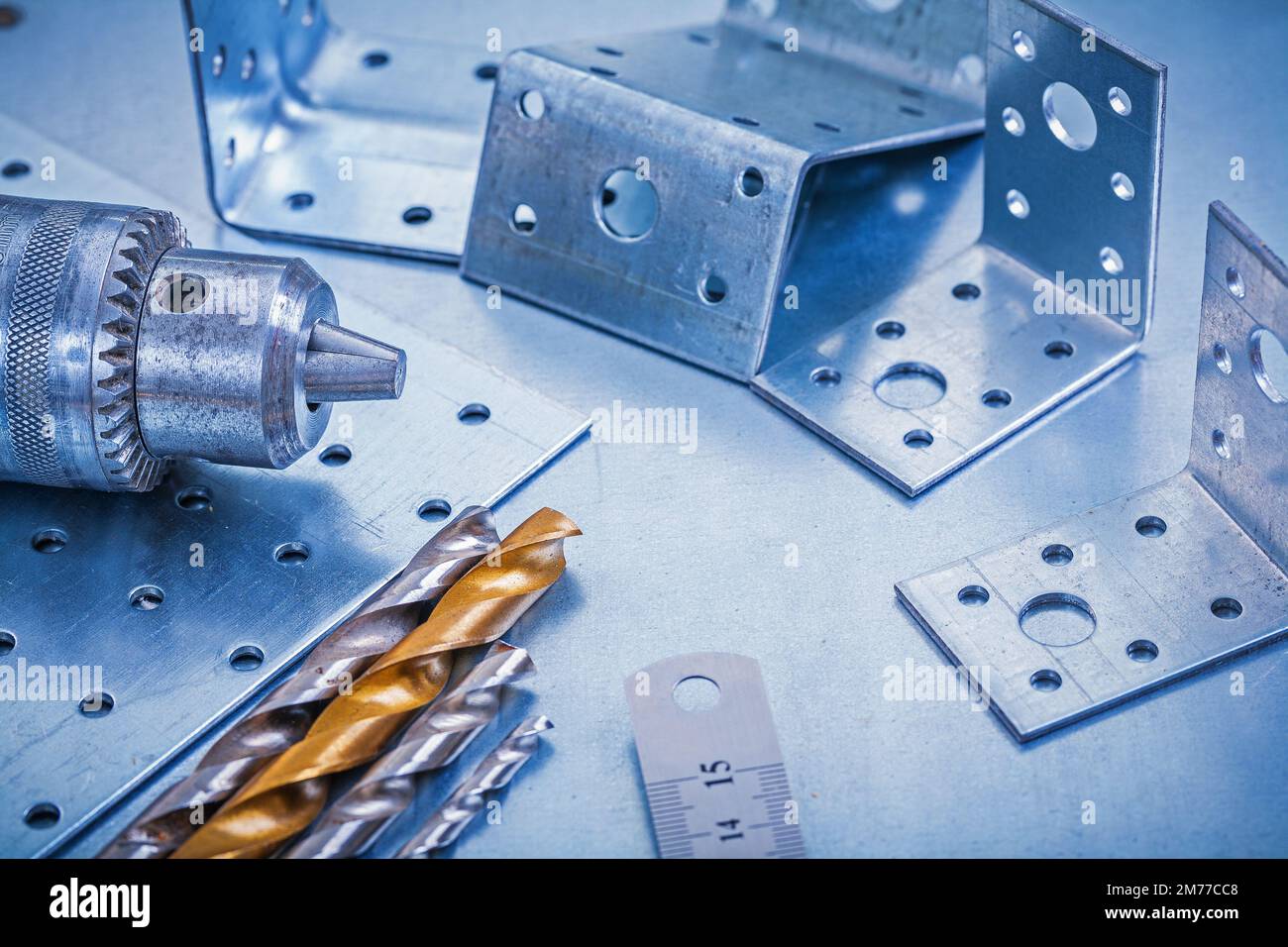 Perforated angle bars sheet metal ruler drill and bits on metallic ...