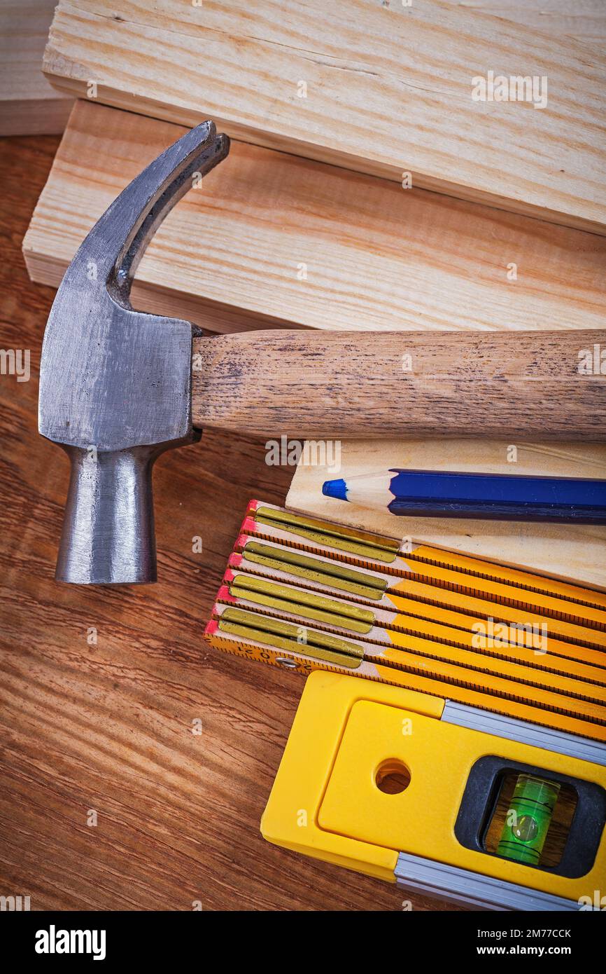 Pencil wooden meter and bricks construction level claw hammer on ...