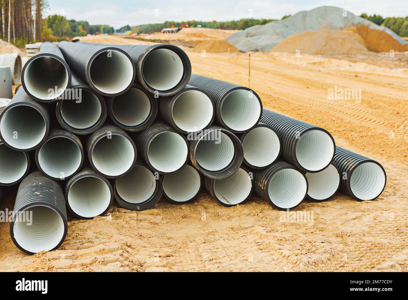 pile of big pipes on construction site Stock Photo - Alamy