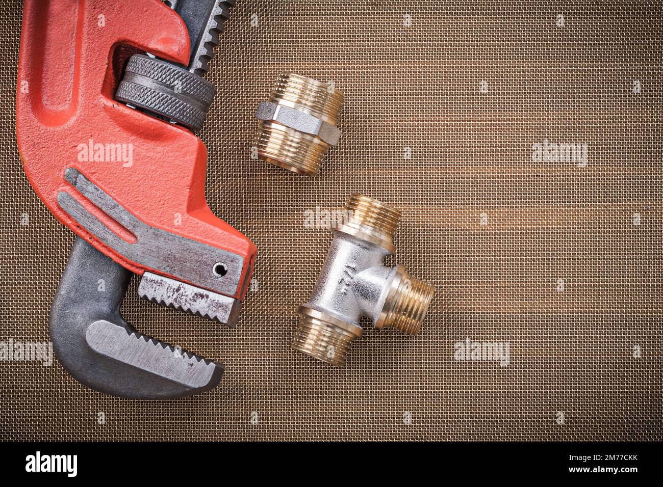 Pipe wrench brass plumbing fixtures on cleaning mesh filter grid Stock ...