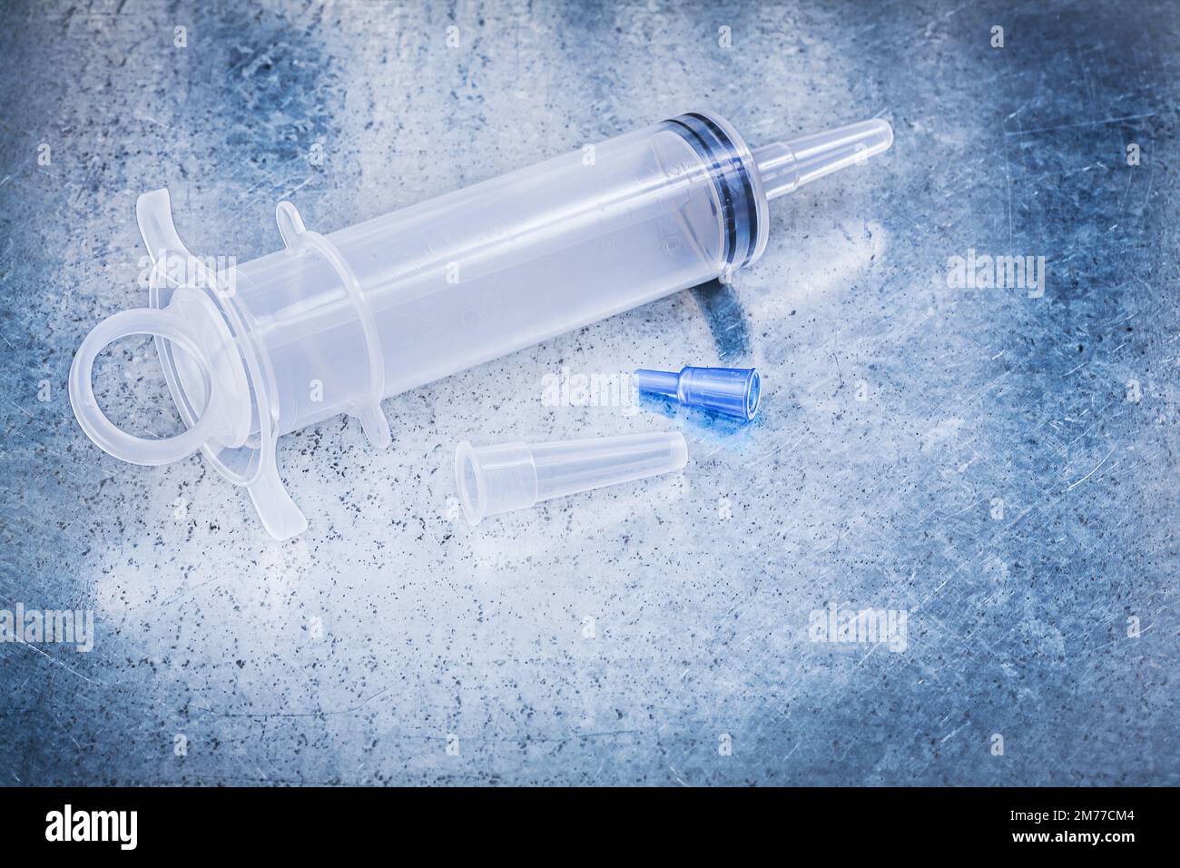 Plastic single-use injector on metallic background top view medicine ...