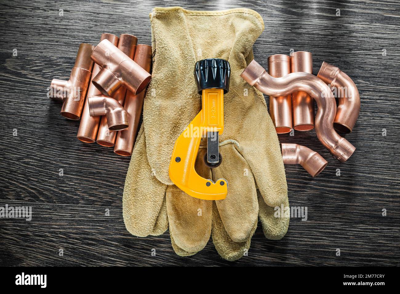 Plumbing water pipe scissors leather safety gloves on wooden board top ...