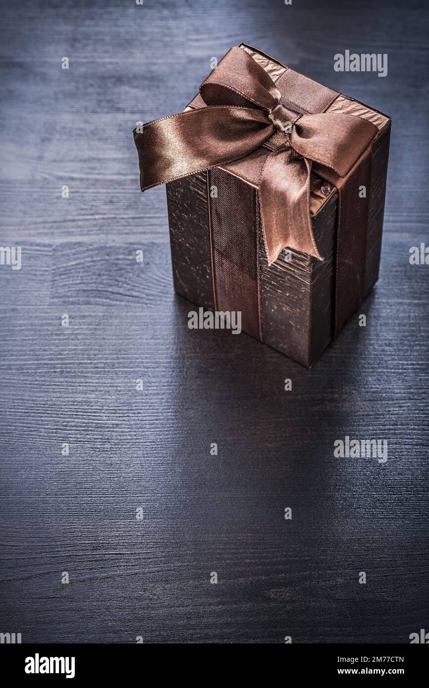 Present box glittery paper tied ribbon on wood board Stock Photo - Alamy