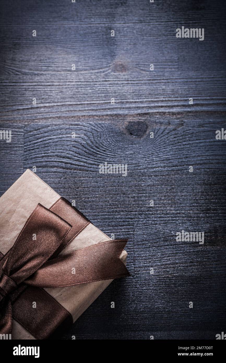 Present box-container with brown tied tape on vintage wooden surface ...