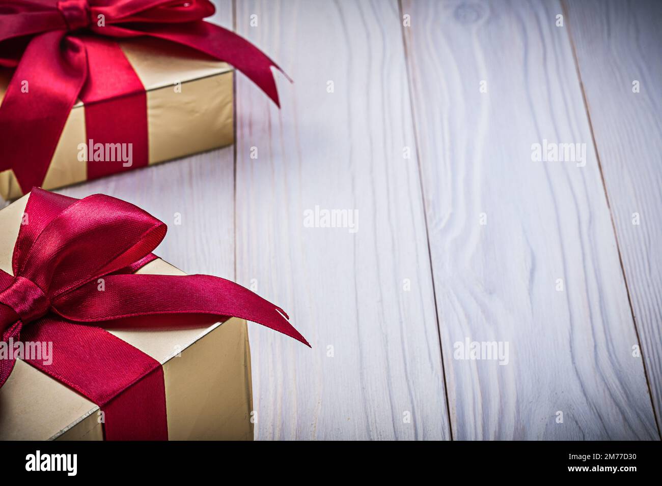 Present boxes with satin ribbons on wood board copy space holidays ...
