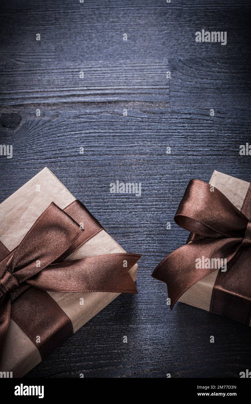 Present containers with tied ribbons on wood board holiday concept ...