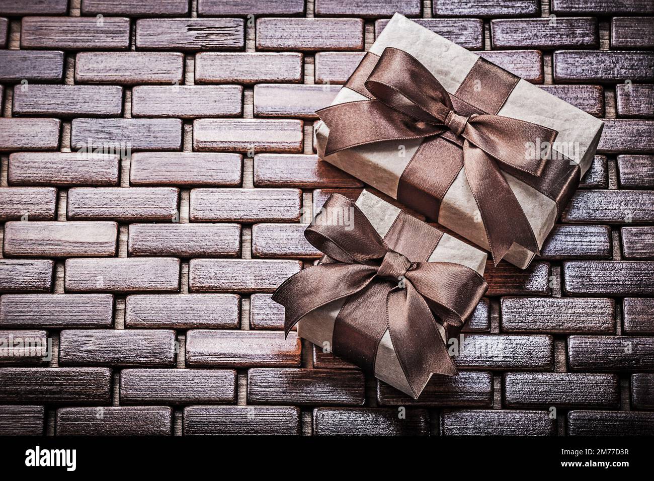 Present boxes with tied ribbons on wooden mat holidays concept Stock ...